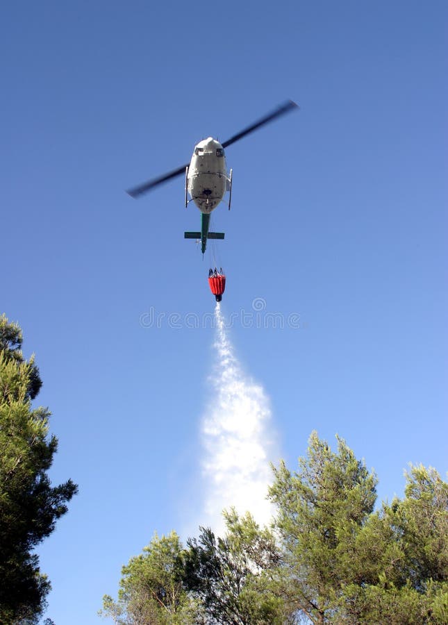 Firefight Helicopter Dropping Water Over Fire on a Forest Editorial ...