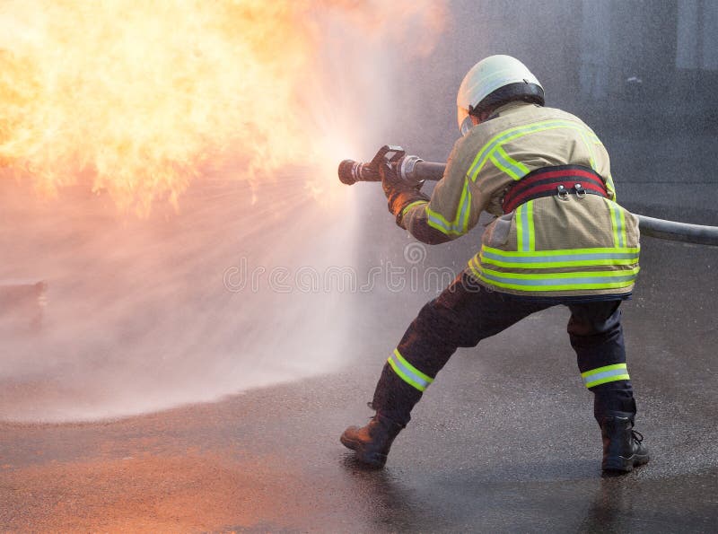 Firefighter in action stock image. Image of explosion - 63439105