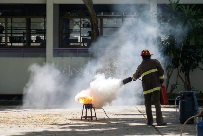 Firefighter in Action with a Fire Extinguisher Stock Photo - Image of ...