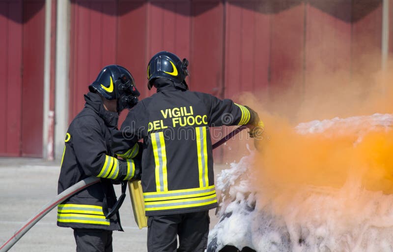 Firefighter in Action with Foam To Put Out the Fire Stock Photo - Image ...