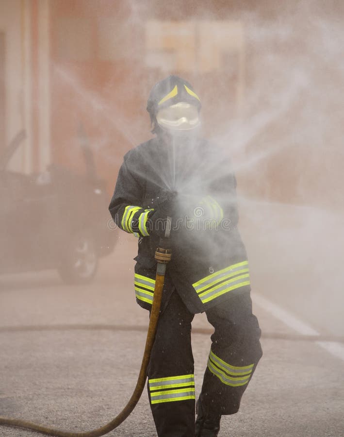 Firefighter in Action with the Foaming Agent during an Emergency Stock ...