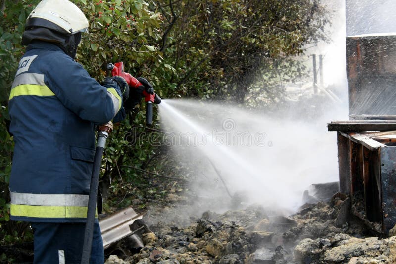 Firefighter Putting Out Fire Stock Image - Image of firefighter ...
