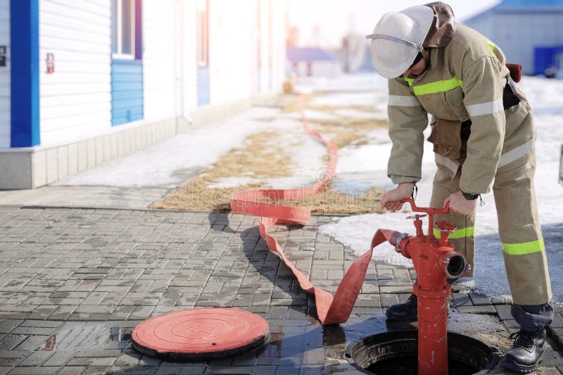 Firefighter Attaching Hose To Hydrant Stock Image - Image of scenario ...
