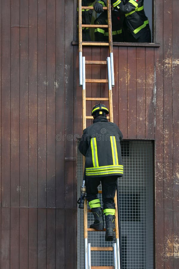 Firefighter is Climbing a Ladder during a Training Exercise at a Fire ...