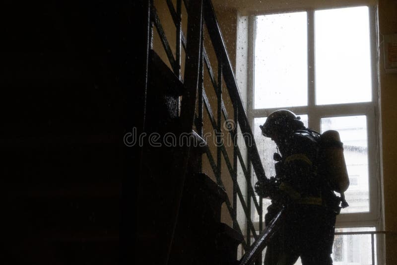 Firefighter Climbs the Stairs of a Building Set on Fire by a Russian ...