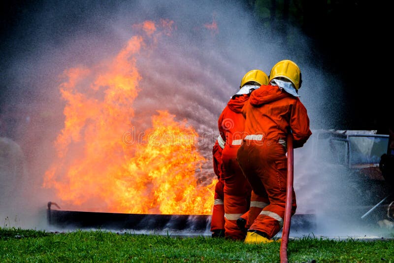 Firefighter Concept. Fireman Using Water and Extinguisher To Fighting ...