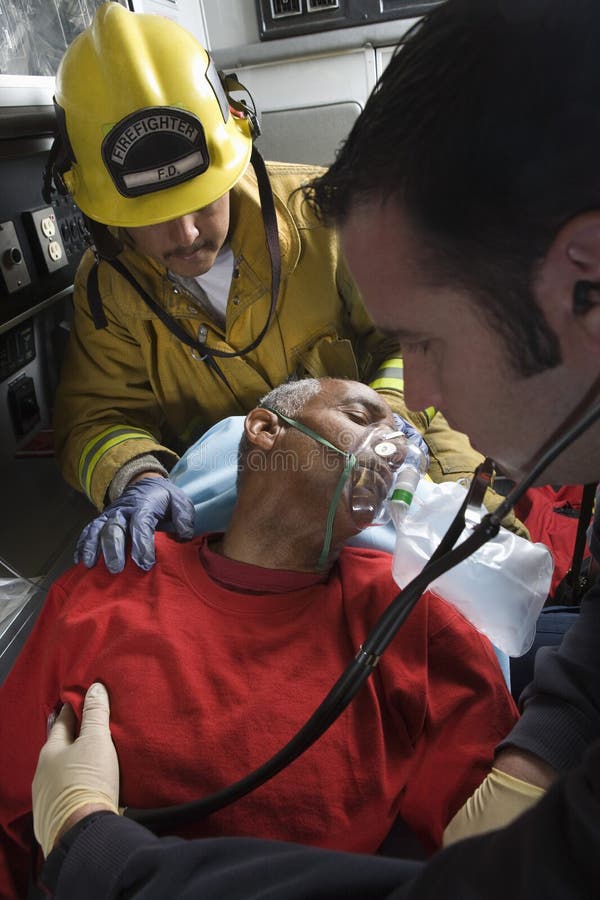 Firefighter and Doctor Taking Care of Senior Man Stock Image - Image of ...