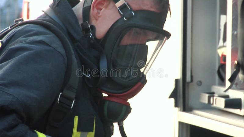 Firefighter Dressed in Uniform and an Oxygen Mask. a Fire in an ...