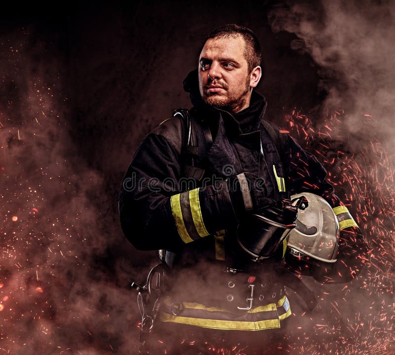 A Firefighter Dressed in a Uniform in a Studio. Stock Photo - Image of ...