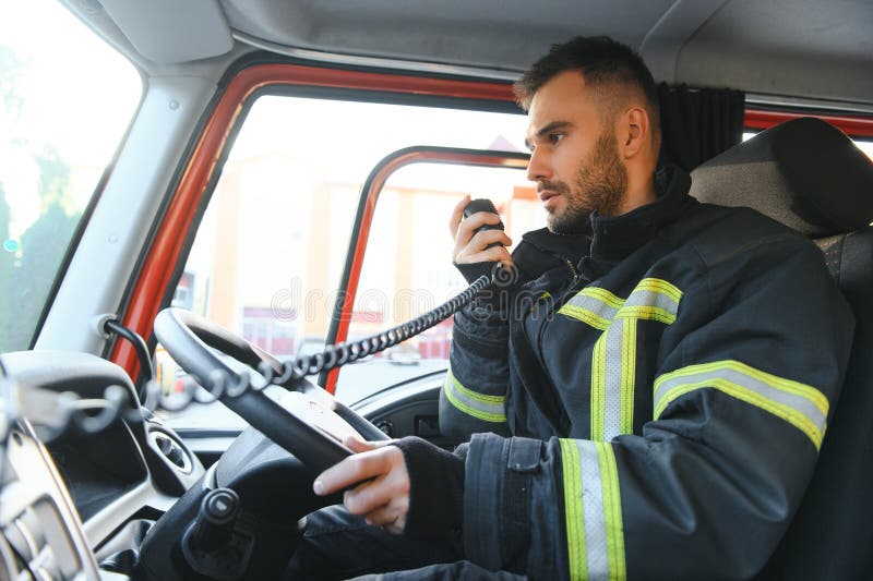 Firefighter Drives a Emergency Vehicle with Communication Interior View ...