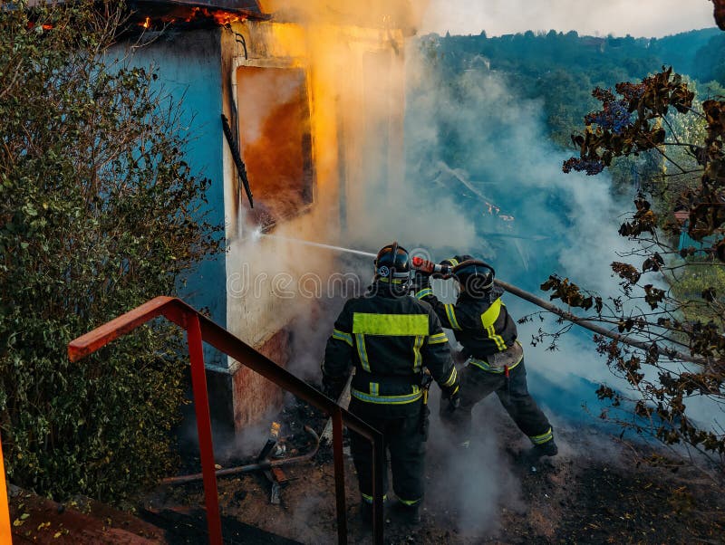 Firefighter Extinguish Fire in House Using Spraying Hose Stock Photo ...
