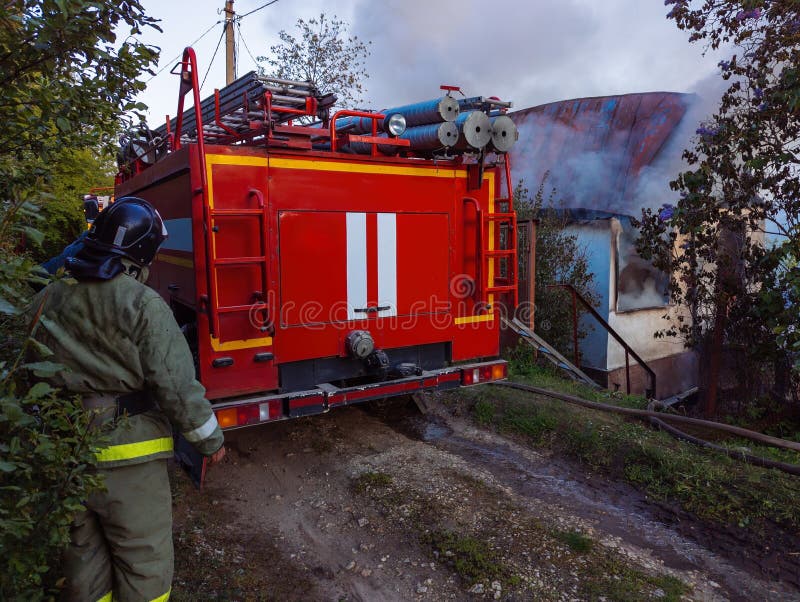 Firefighter Extinguish Fire in House Using Spraying Hose Stock Photo ...