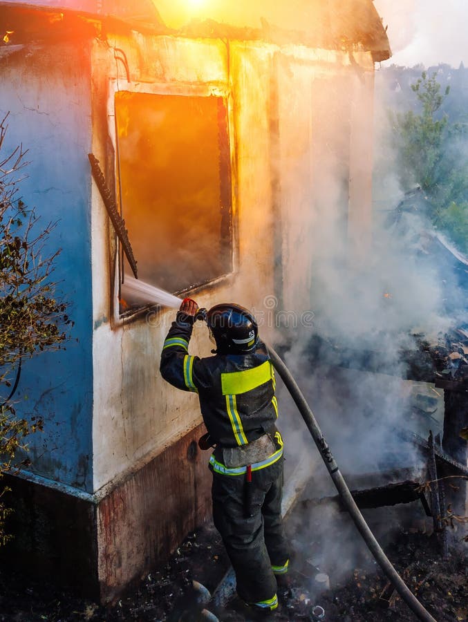 Firefighter Extinguish Fire in House Using Spraying Hose Stock Image ...