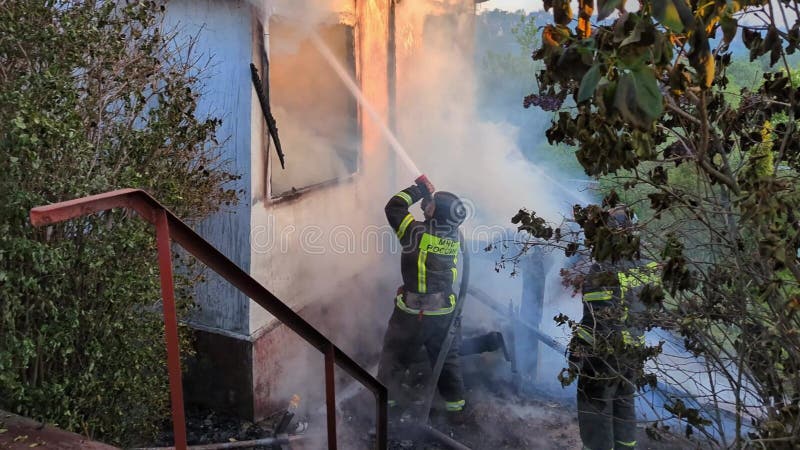 Firefighter Extinguish Fire in House Using Spraying Hose Stock Footage ...