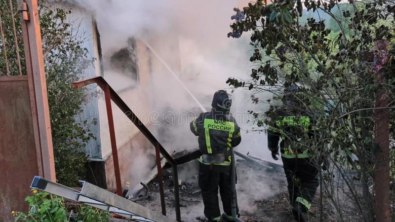 Firefighter Extinguish Fire in House Using Spraying Hose Stock Footage ...