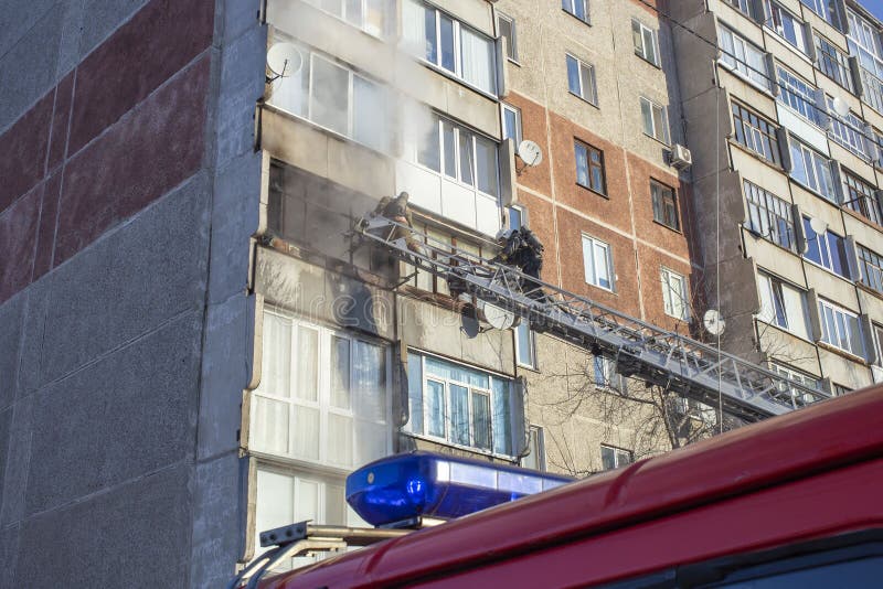 A Firefighter Extinguishes a Balcony, in a High-rise Building, from a ...