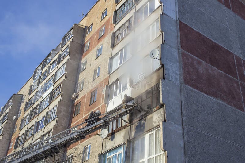 A Firefighter Extinguishes a Balcony, in a High-rise Building, from a ...