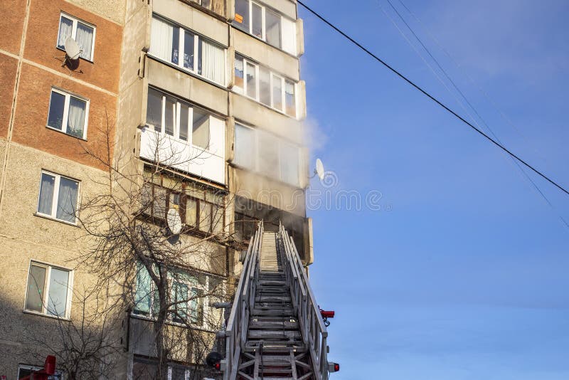 A Firefighter Extinguishes a Balcony, in a High-rise Building, from a ...