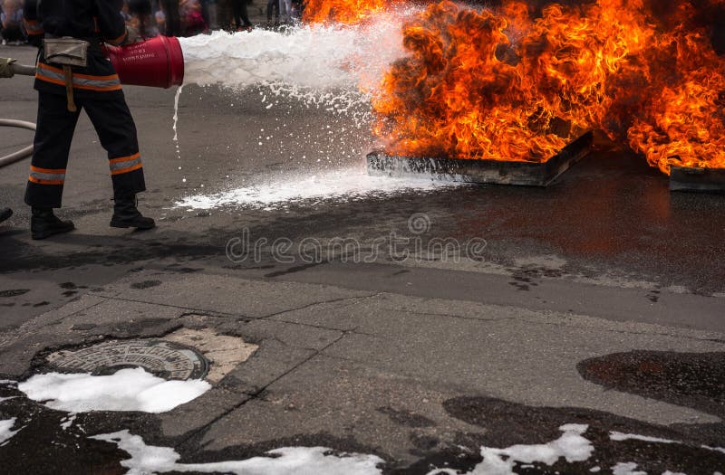 Firefighter Extinguishes the Fire with Smoke Stock Photo - Image of ...