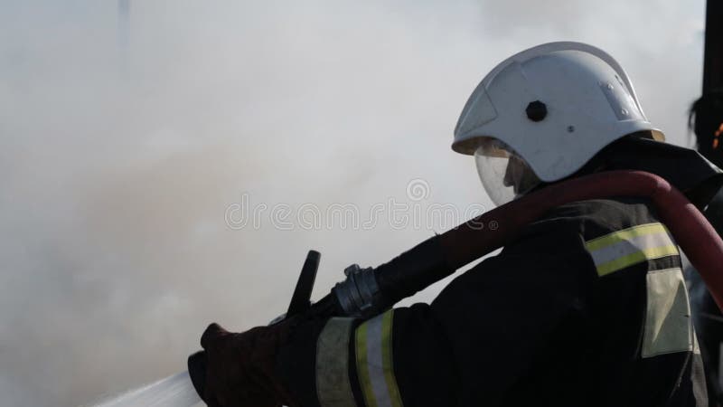 Firefighter Extinguishes Fire with a Water Jet Stock Video - Video of ...