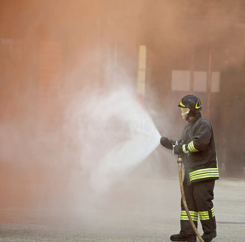 Firefighter Extinguishes a Large Fire Editorial Image - Image of ...