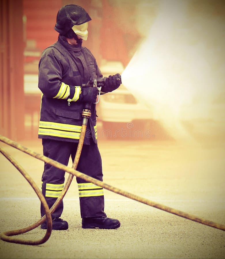 Firefighter during Fire Extinguishing and Old Toned Effect Stock Photo ...
