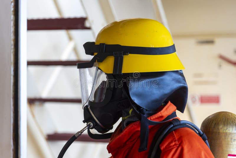 A Firefighter in Full Protective Gear, Mask, and Oxygen Tank Stands ...