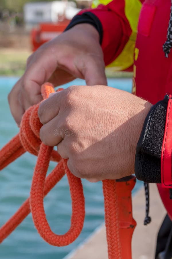 Firefighter Hands Tying Rope Knot, Vertical Photo Stock Image - Image ...
