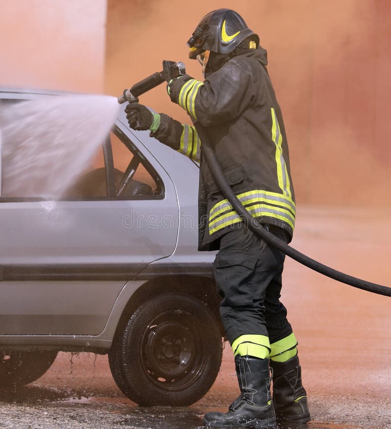 Firefighter with Helmet Uses Foam during a Road Accident Stock Image ...