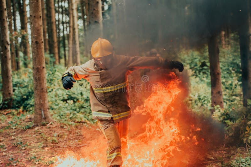 Firefighter Hero in Action Danger Jumping Over Fire Flame To Rescue and ...