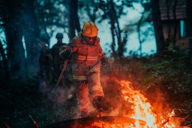 Firefighter Hero in Action Danger Jumping Over Fire Flame To Rescue and ...