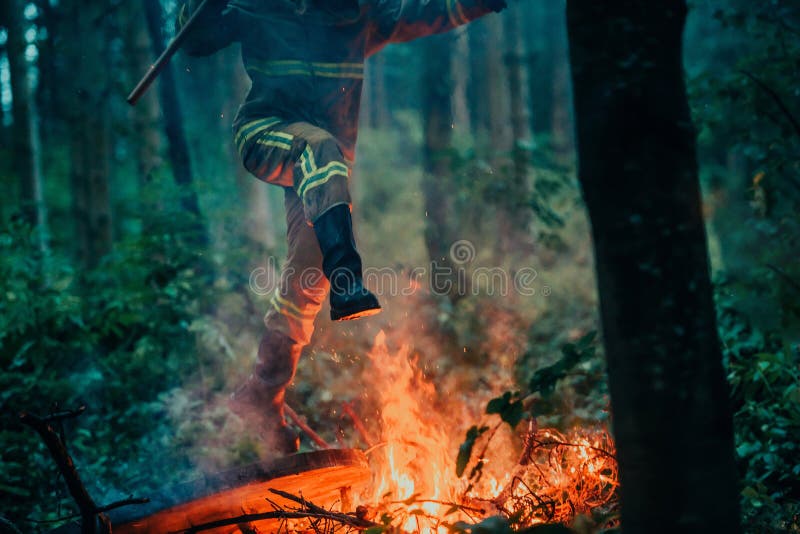 Firefighter Hero in Action Danger Jumping Over Fire Flame To Rescue and ...