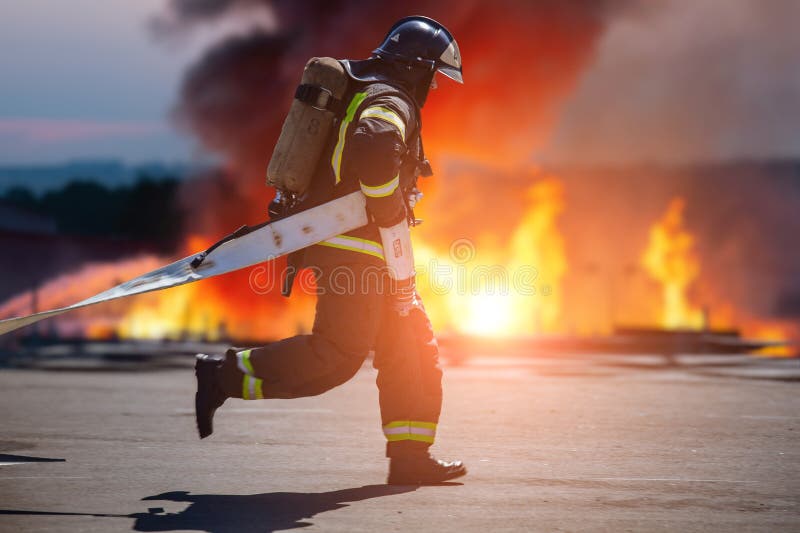 Firefighter with Hose Running To Burning Fire Stock Image - Image of ...