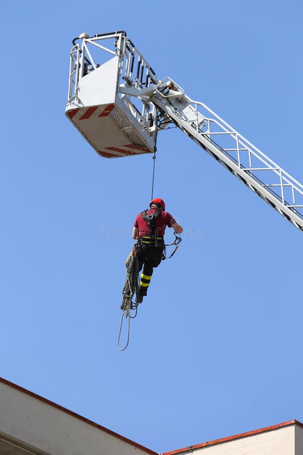 Two Firefighters with a Rope during the Rescue Operation Stock Image ...