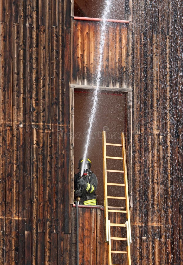 Firefighter with Hydrant in Action when Switching Off a Fire during ...
