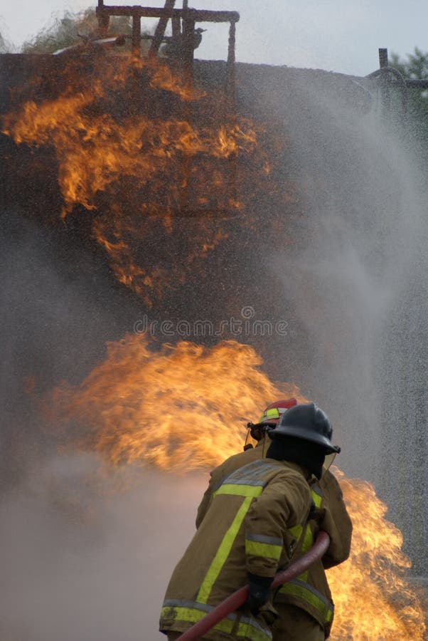 Firefighter at Large Blaze in Petroleum Refinery Stock Photo - Image of ...