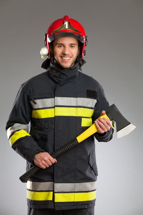 Firefighter Posing with Helmet Under His Arm Stock Photo - Image of ...