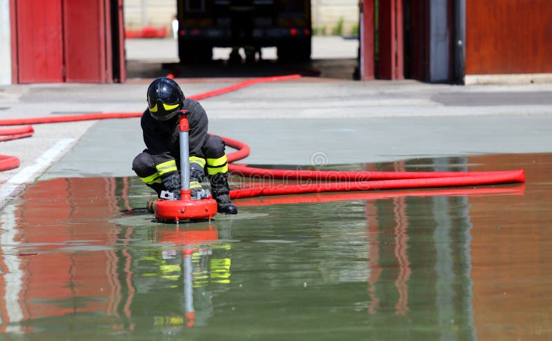 Firefighter Positions a Powerful Fire Hydrant during the Exercises ...