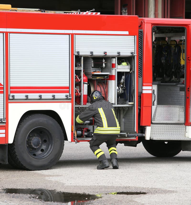 Firefighter Prepares the Water Hoses To Put Out the Fire Stock Photo ...