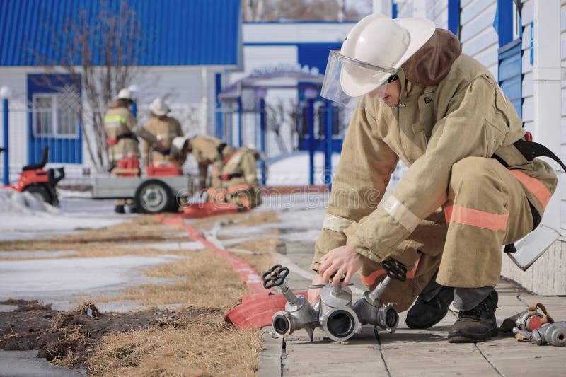 Firefighter Preparing Equipment during Daytime Training Exercise. Stock ...