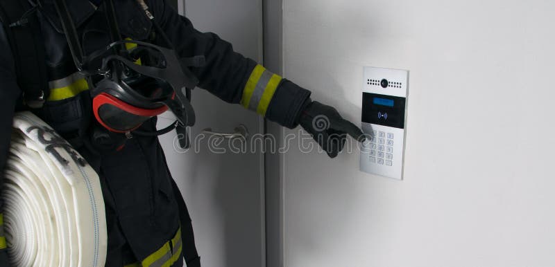 A Firefighter Tries To Open the Iron Entrance Door with an Intercom in ...