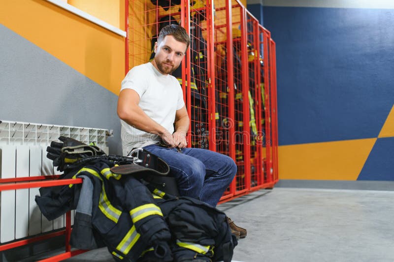 A Firefighter Puts on a Fire Uniform at the Fire Department Stock Image ...