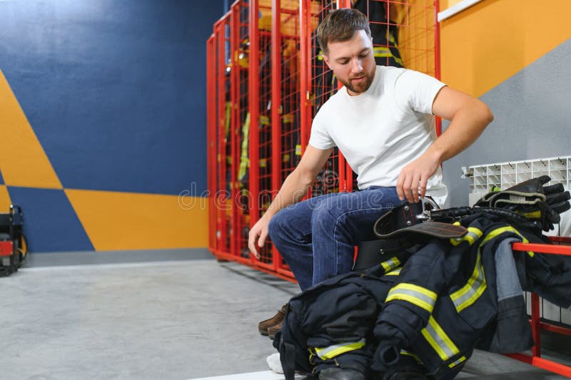 A Firefighter Puts on a Fire Uniform at the Fire Department Stock Photo ...