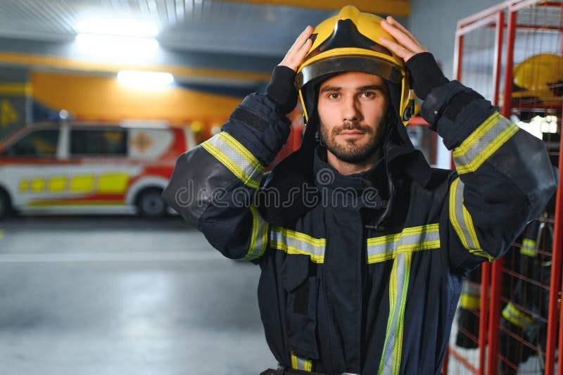 A Firefighter Puts on a Fire Uniform at the Fire Department Stock Photo ...