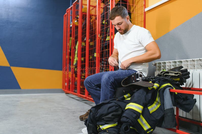 A Firefighter Puts on a Fire Uniform at the Fire Department Stock Image ...