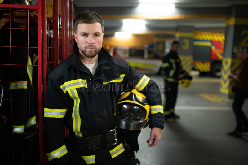 A Firefighter Puts on a Fire Uniform at the Fire Department Stock Photo ...