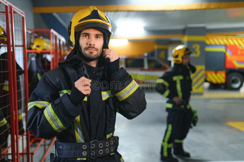 A Firefighter Puts on a Fire Uniform at the Fire Department Stock Photo ...