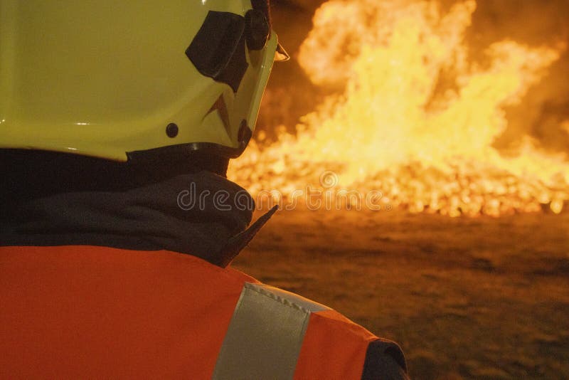 Firefighter Putting Out a Fire. Destruction and Disaster Stock Photo ...