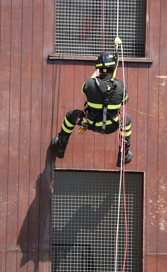 Firefighter is Rappelling Down the Building in Full Uniform a Stock ...