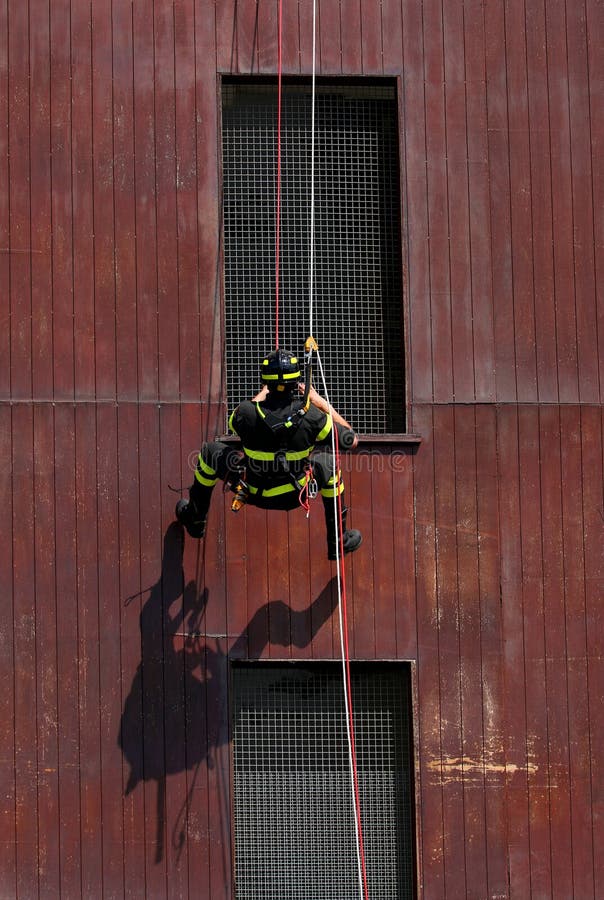 Firefighter Rappels from a Fire Station during a Training Exercise ...